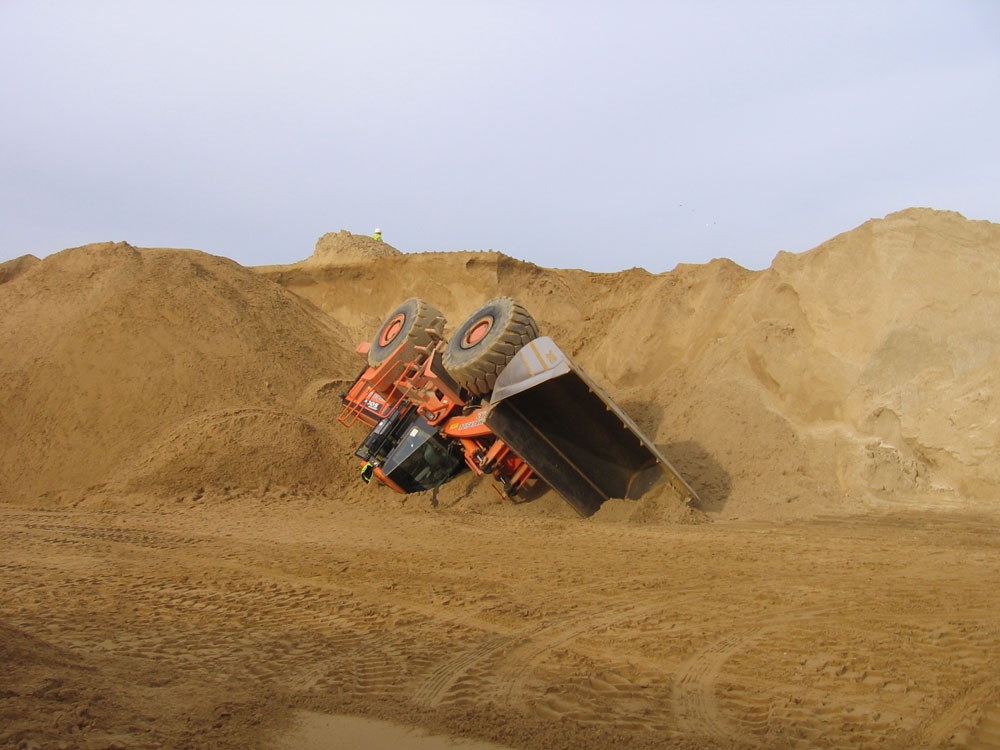 30-tonne loader overturns and slides down quarry | Construction News